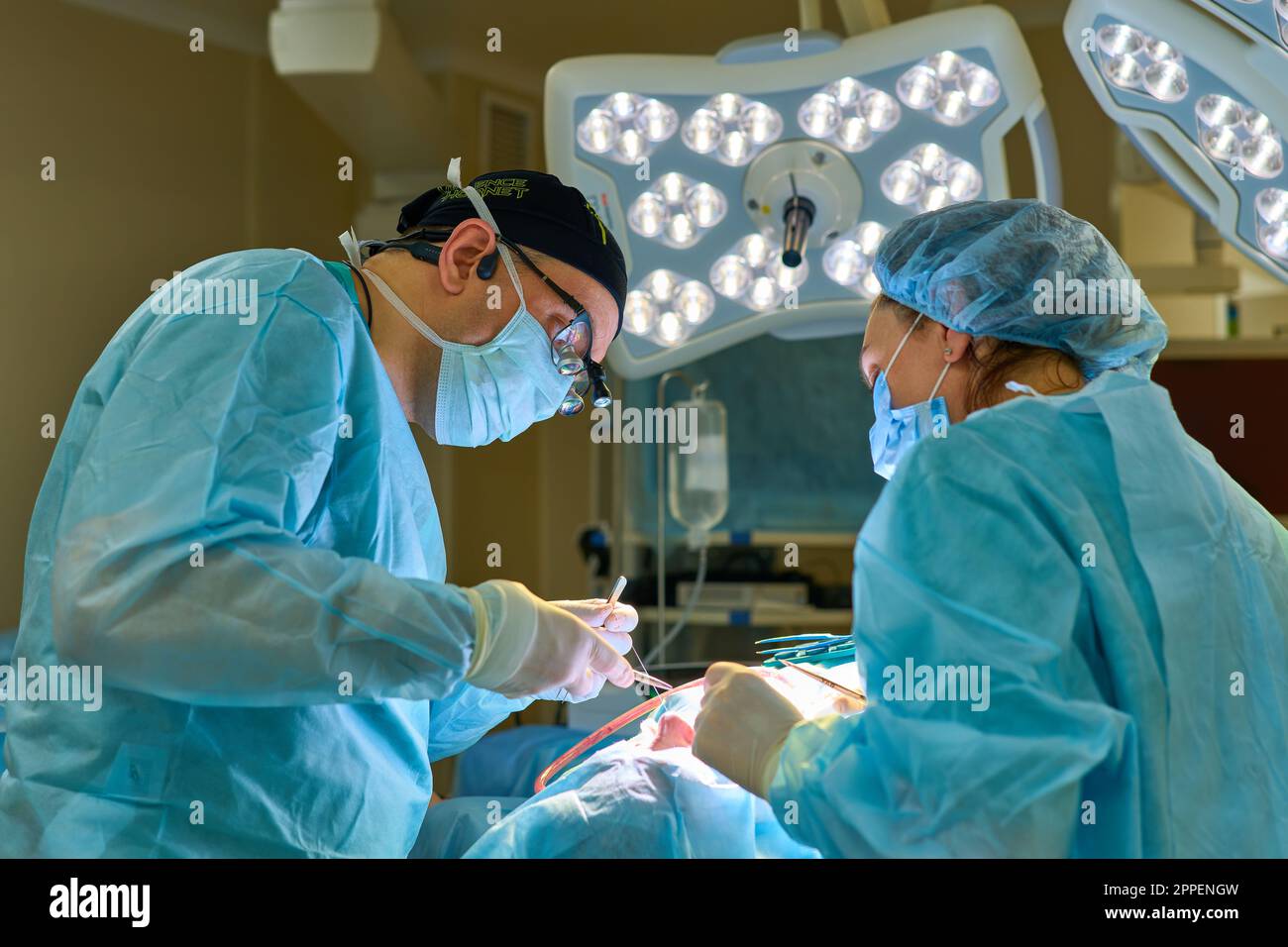 plastic surgeon operates on a patient in the operating room Stock Photo ...