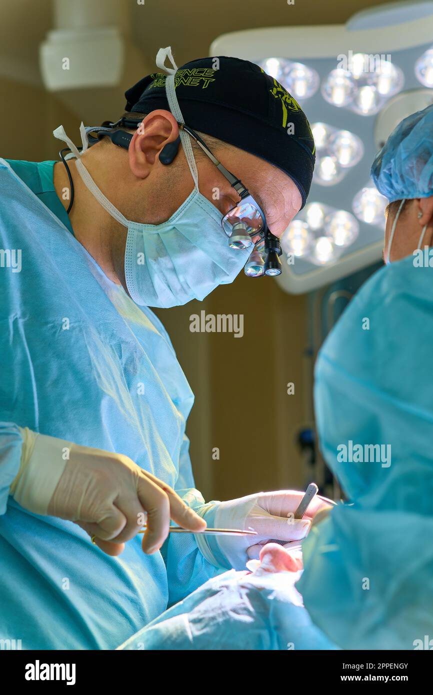 plastic surgeon operates on a patient in the operating room Stock Photo ...