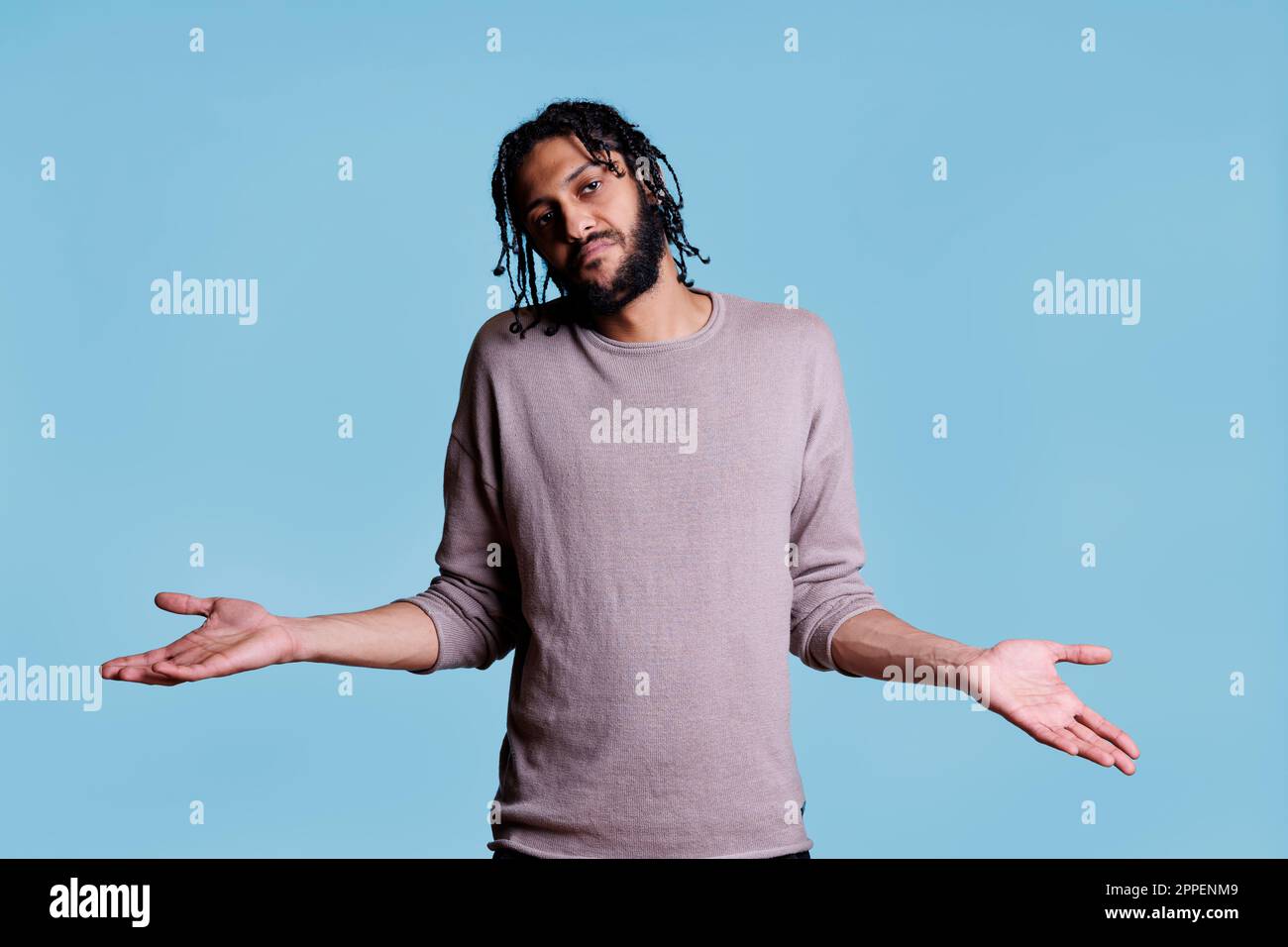 Confused arab man shrugging shoulders with pensive facial expression ...