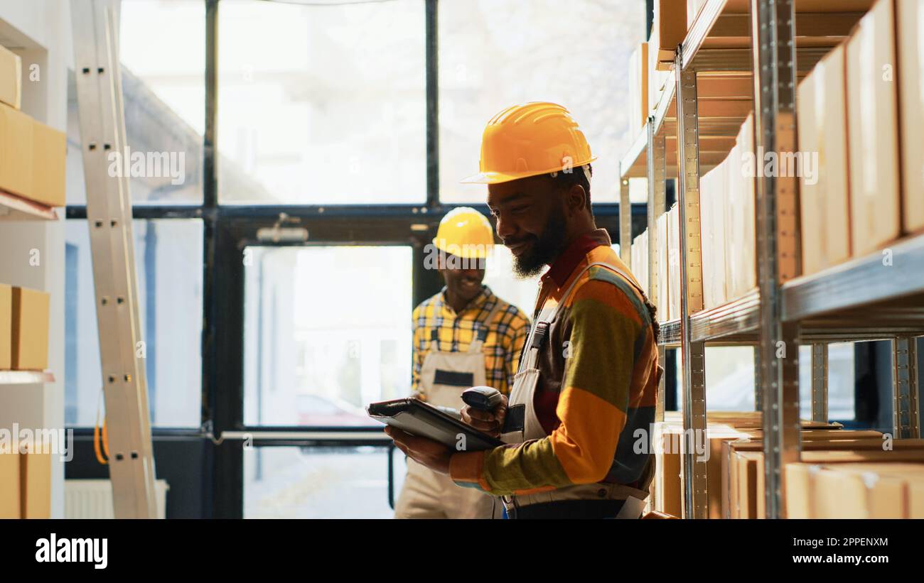 Warehouse employee scanning barcodes on products, using scanner and ...