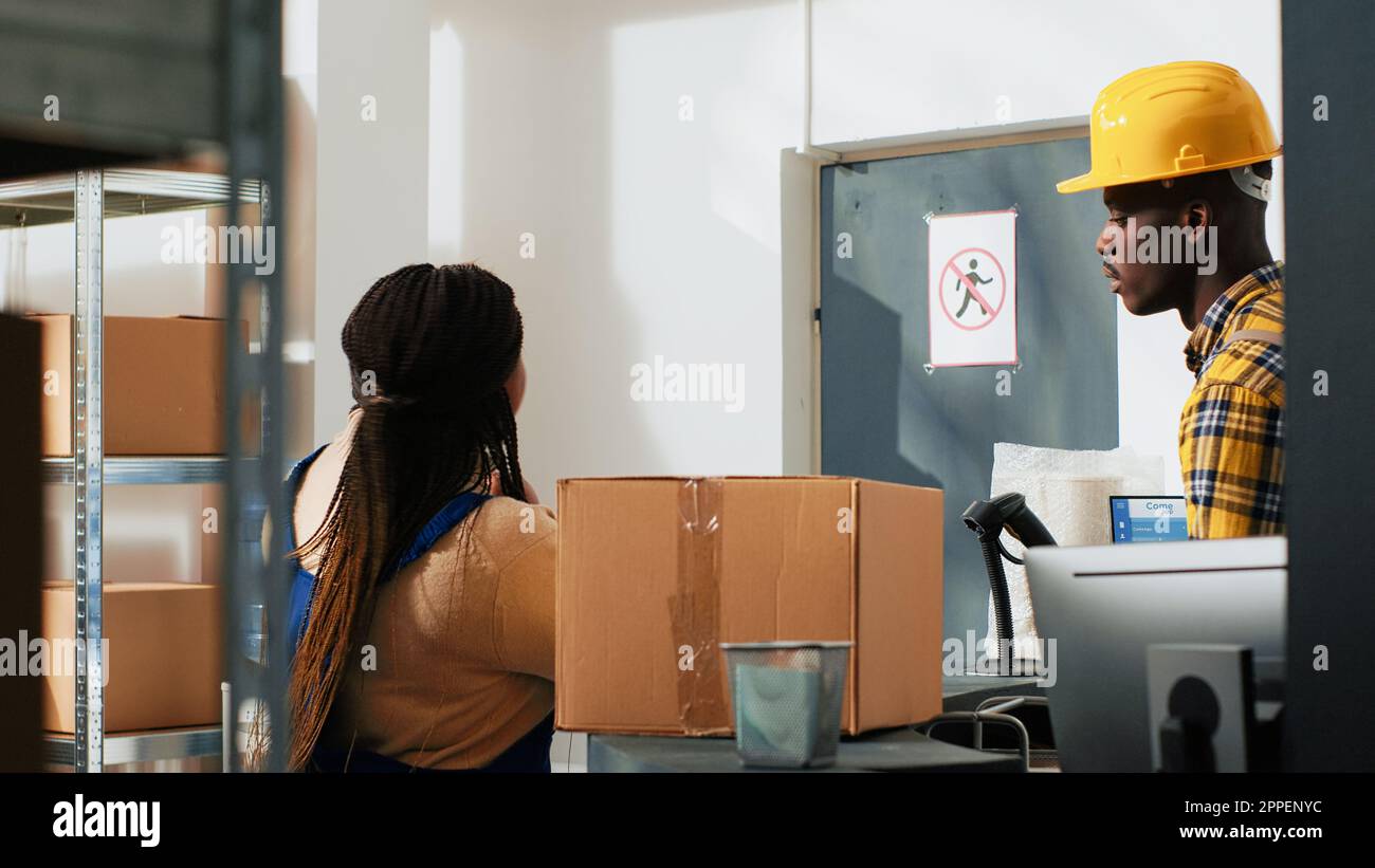 Team of young people working on depot logistics and packing goods ...