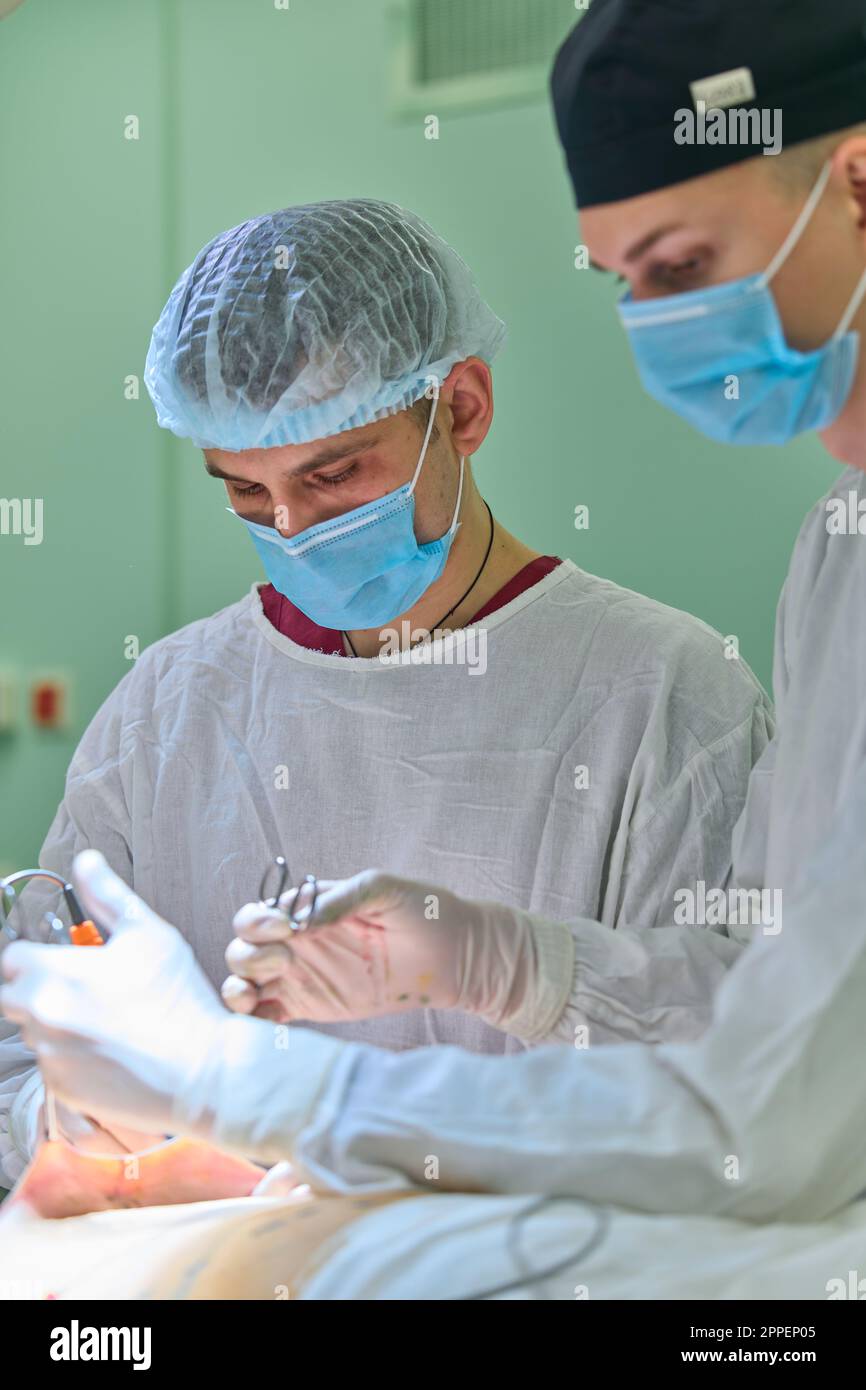 plastic surgeon operates on a patient in the operating room Stock Photo ...