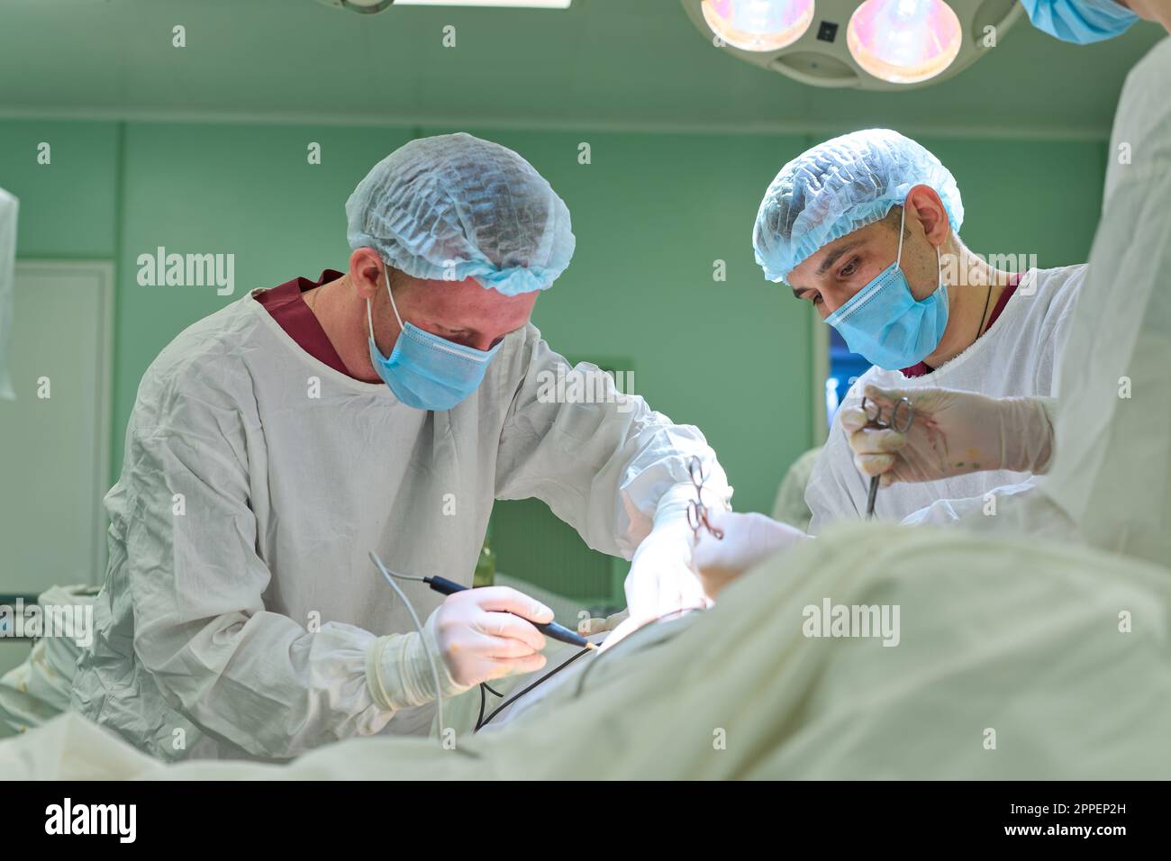 plastic surgeon operates on a patient in the operating room Stock Photo ...