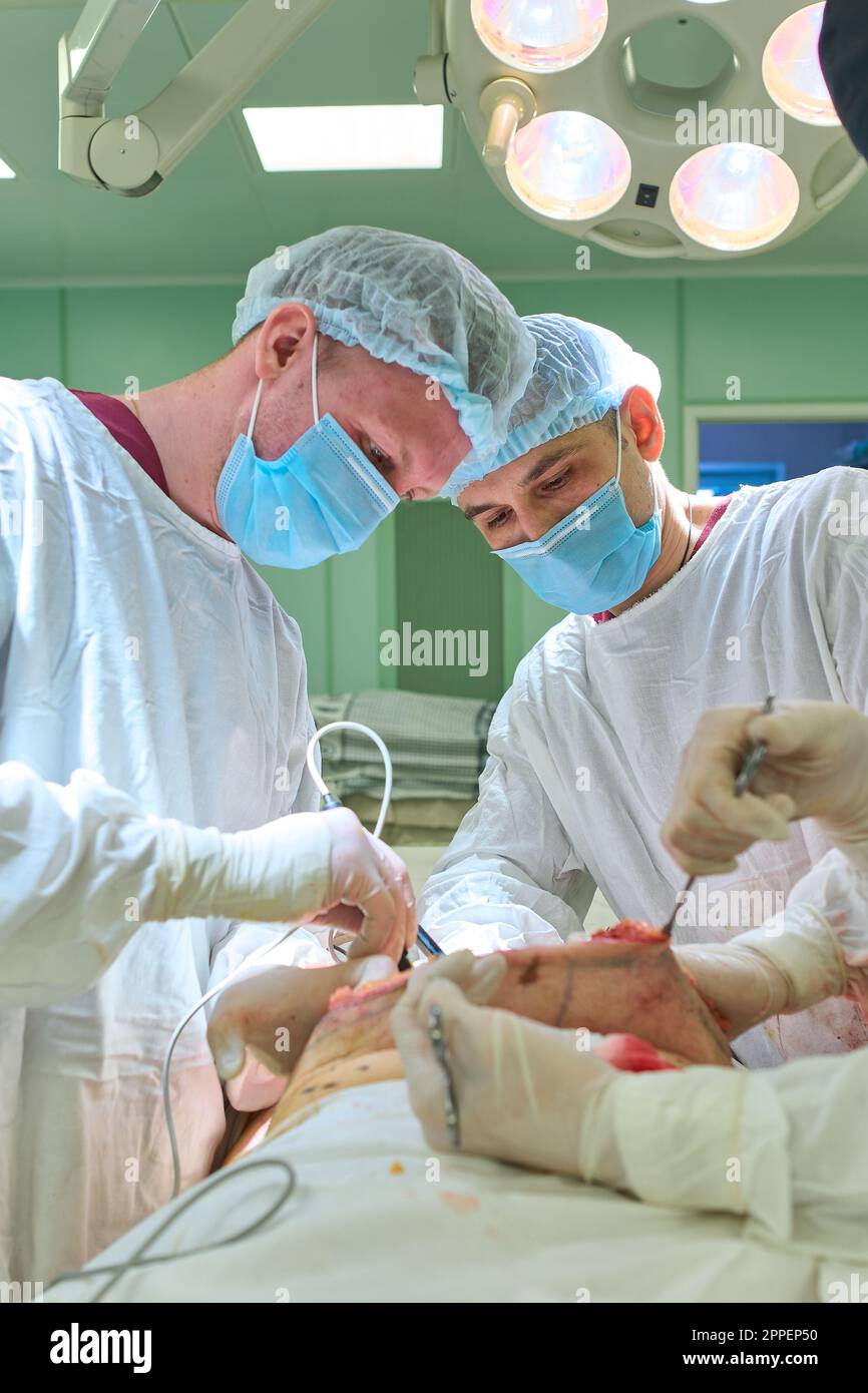 plastic surgeon operates on a patient in the operating room Stock Photo ...