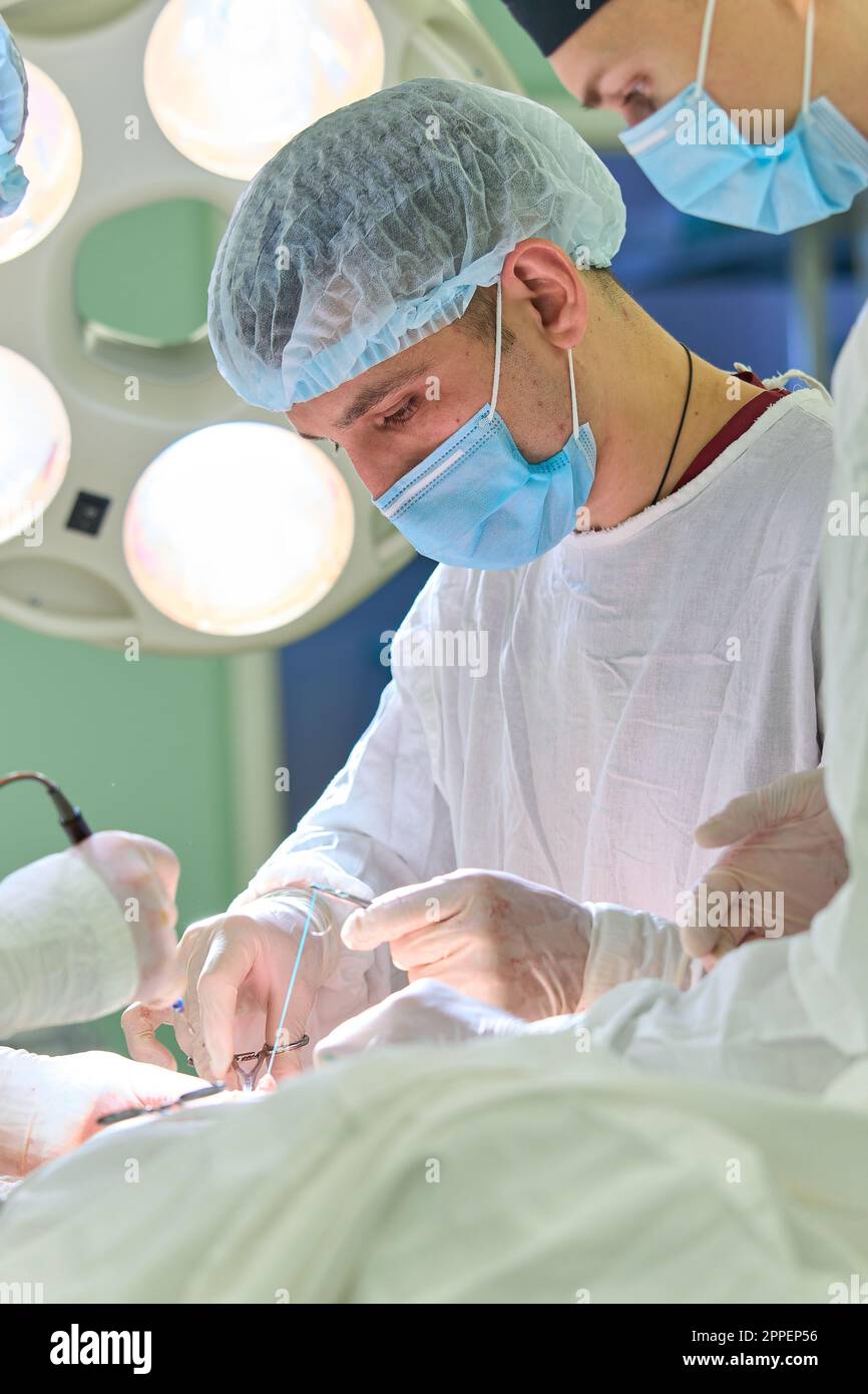 plastic surgeon operates on a patient in the operating room Stock Photo ...