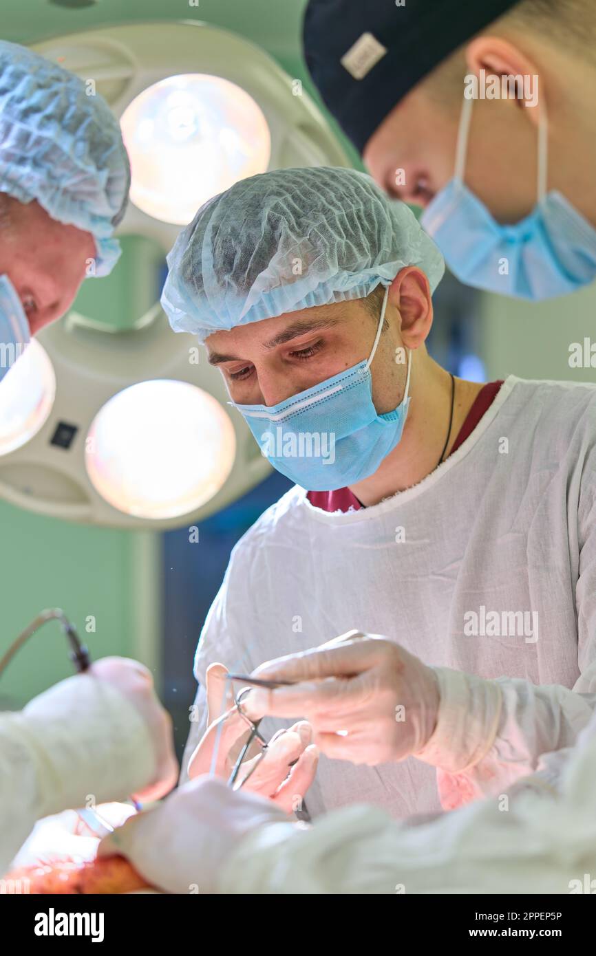 plastic surgeon operates on a patient in the operating room Stock Photo ...