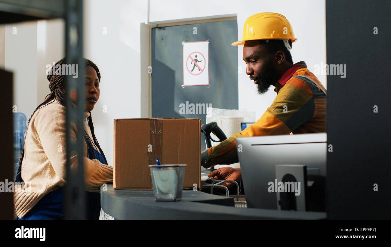 Team of workers bumping fists before finishing shipment, organizing ...