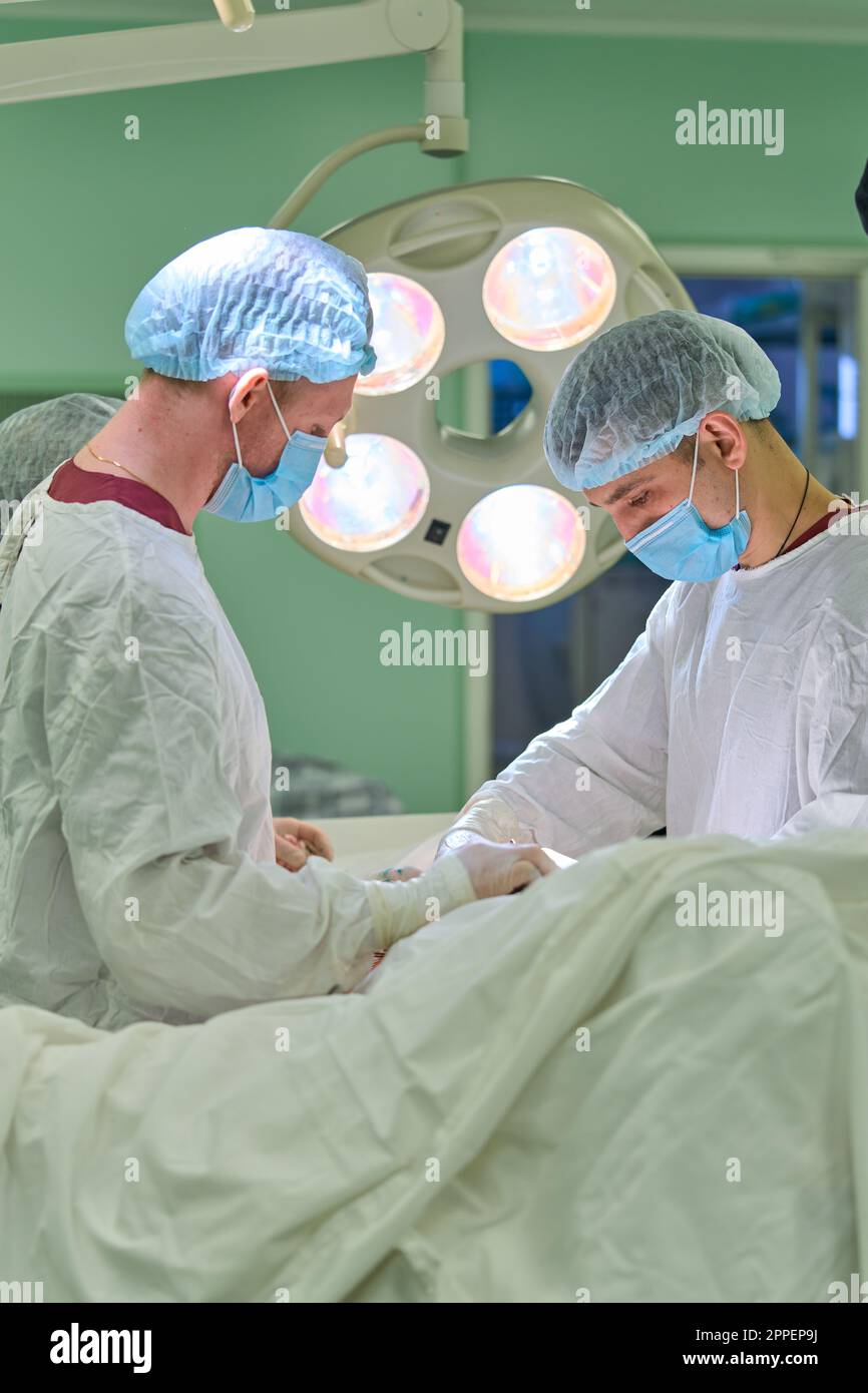 plastic surgeon operates on a patient in the operating room Stock Photo ...