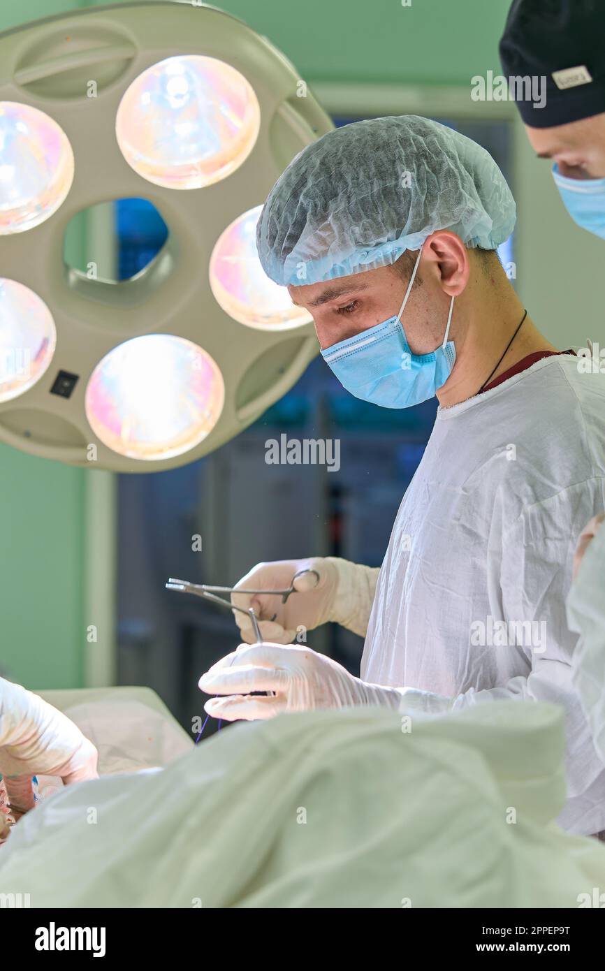 plastic surgeon operates on a patient in the operating room Stock Photo ...
