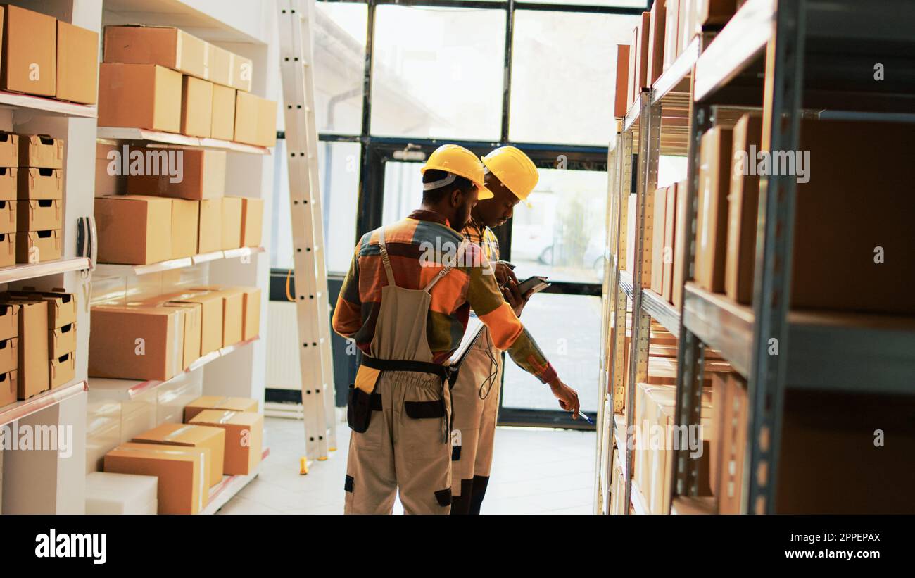 Team of people working on inventory with scanner and list of products ...