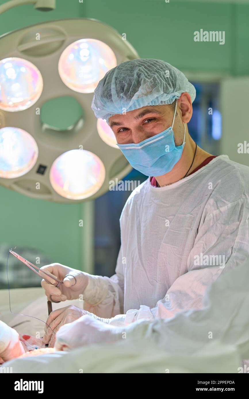 plastic surgeon operates on a patient in the operating room Stock Photo ...