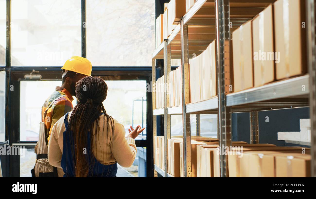 Team of people working on merchandise inventory, scanning barcodes on ...