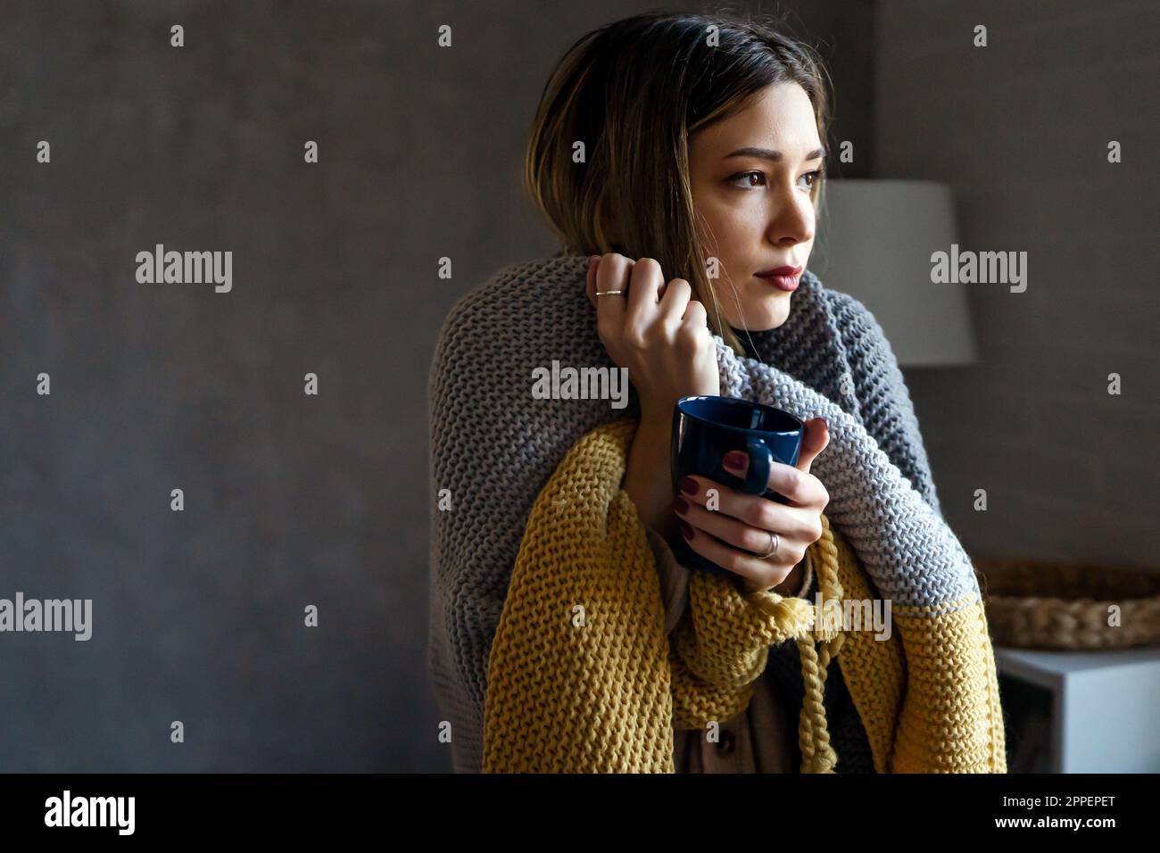 Freezing woman suffering from cold or flu fever or having trouble with ...