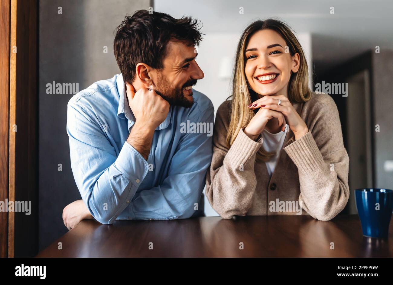 Spending nice time at home. Beautiful young loving couple bonding to ...