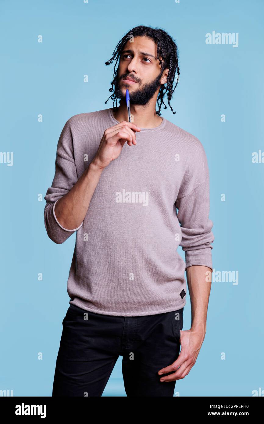 Young arab man standing doubt hi-res stock photography and images - Alamy
