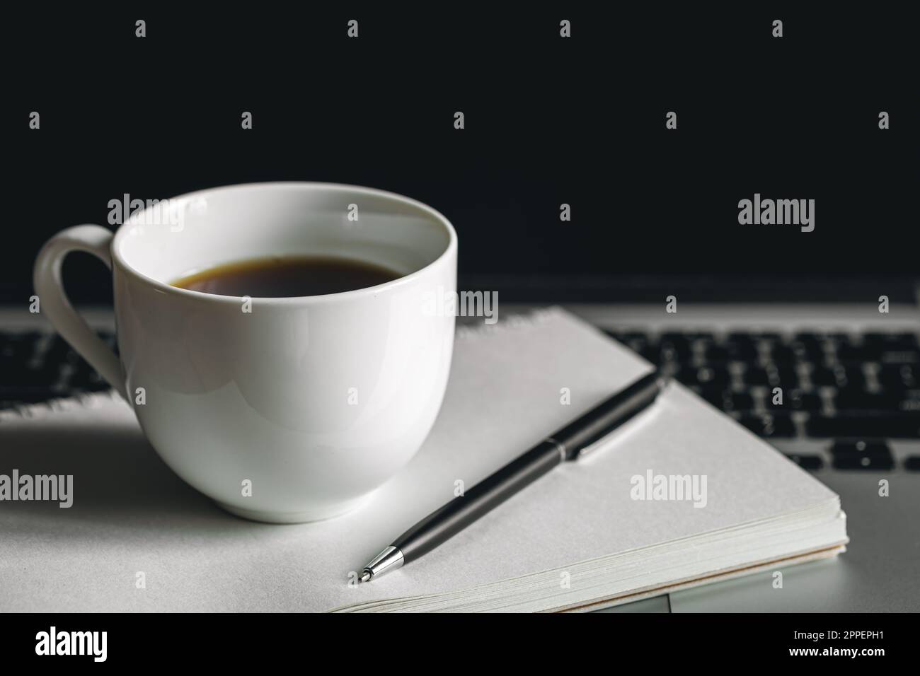 Cup of coffee, notepad and laptop, office work concept Stock Photo - Alamy