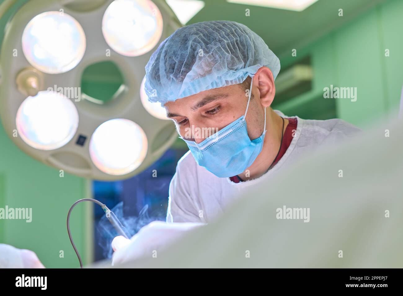 plastic surgeon operates on a patient in the operating room Stock Photo ...