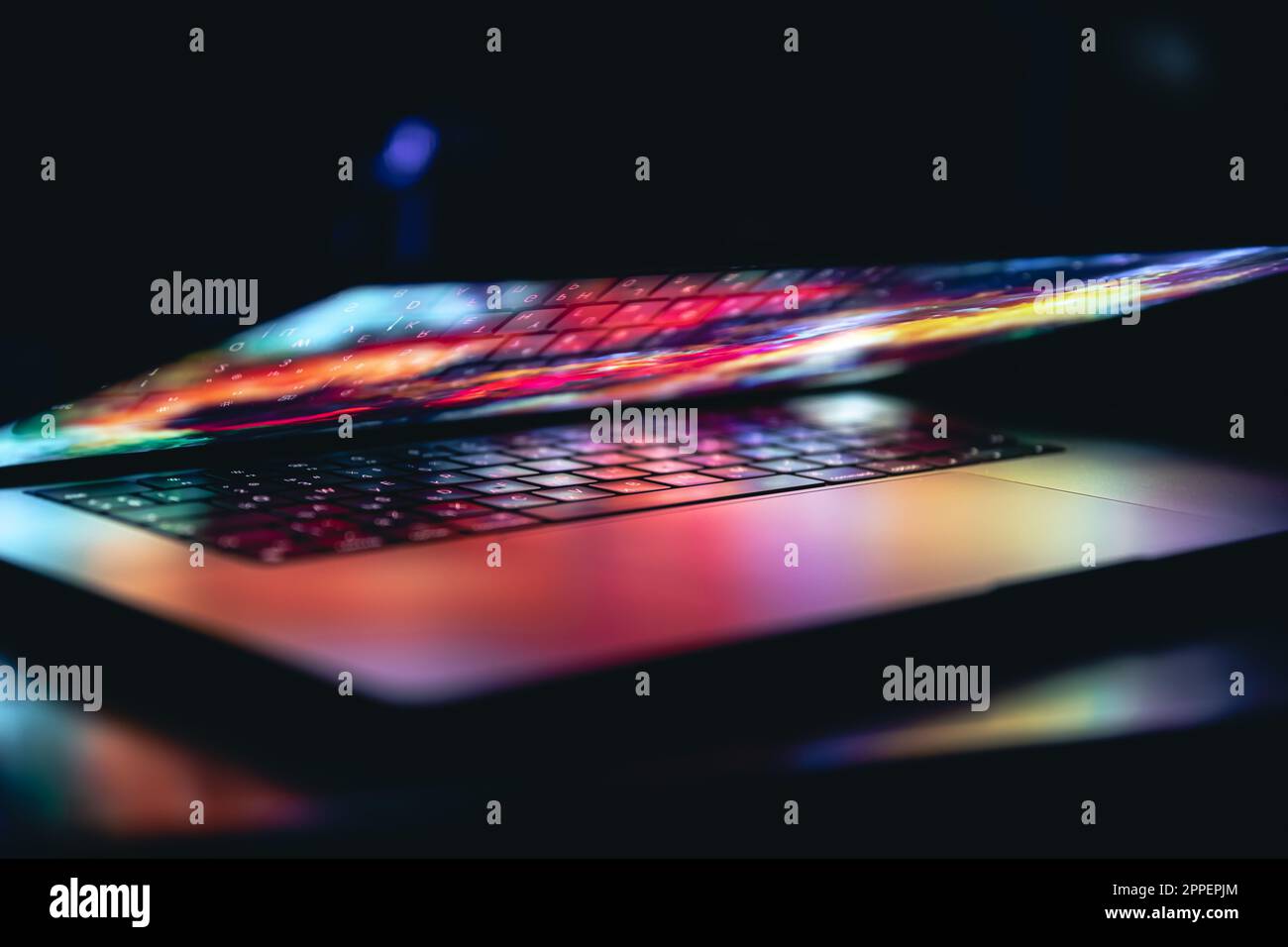 Close up of laptop keyboard colorful neon illumination, backlit ...