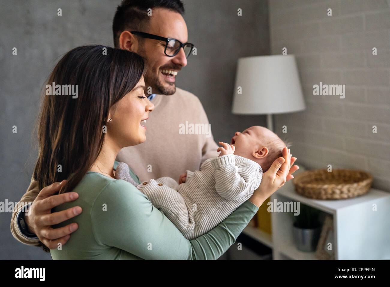 Peaceful young married couple enjoying being family, parents, holding ...