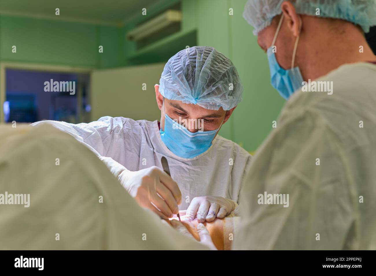 plastic surgeon operates on a patient in the operating room Stock Photo ...