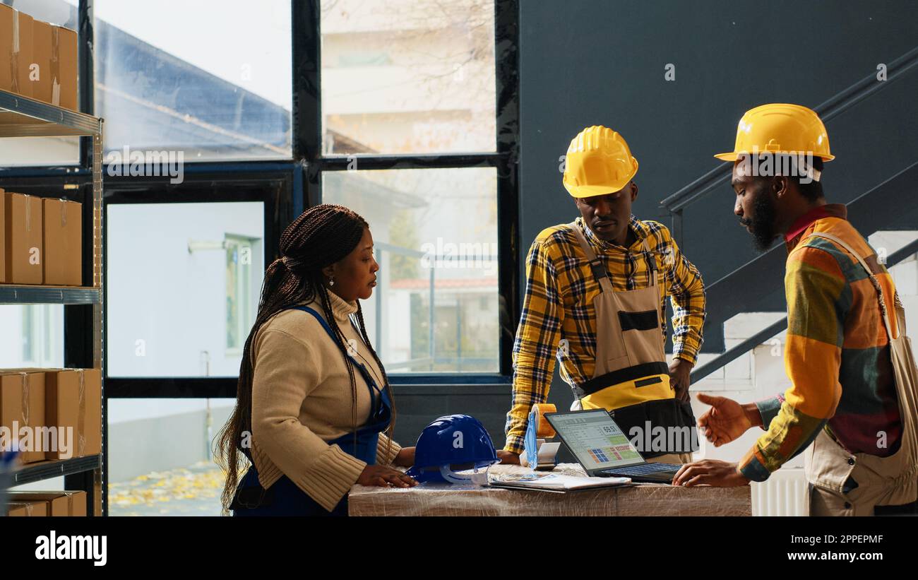 African american employees working on stock logistics and inventory for ...