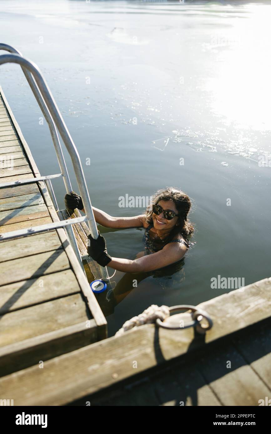 Woman swimming in cold lake Stock Photo - Alamy