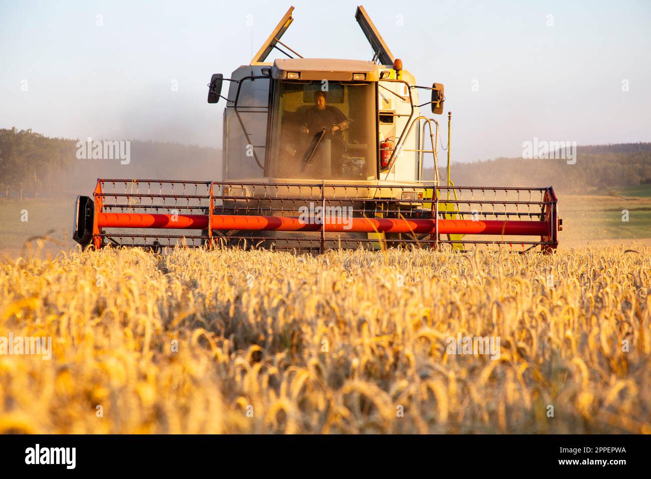 Combine harvester working in field Stock Photo - Alamy
