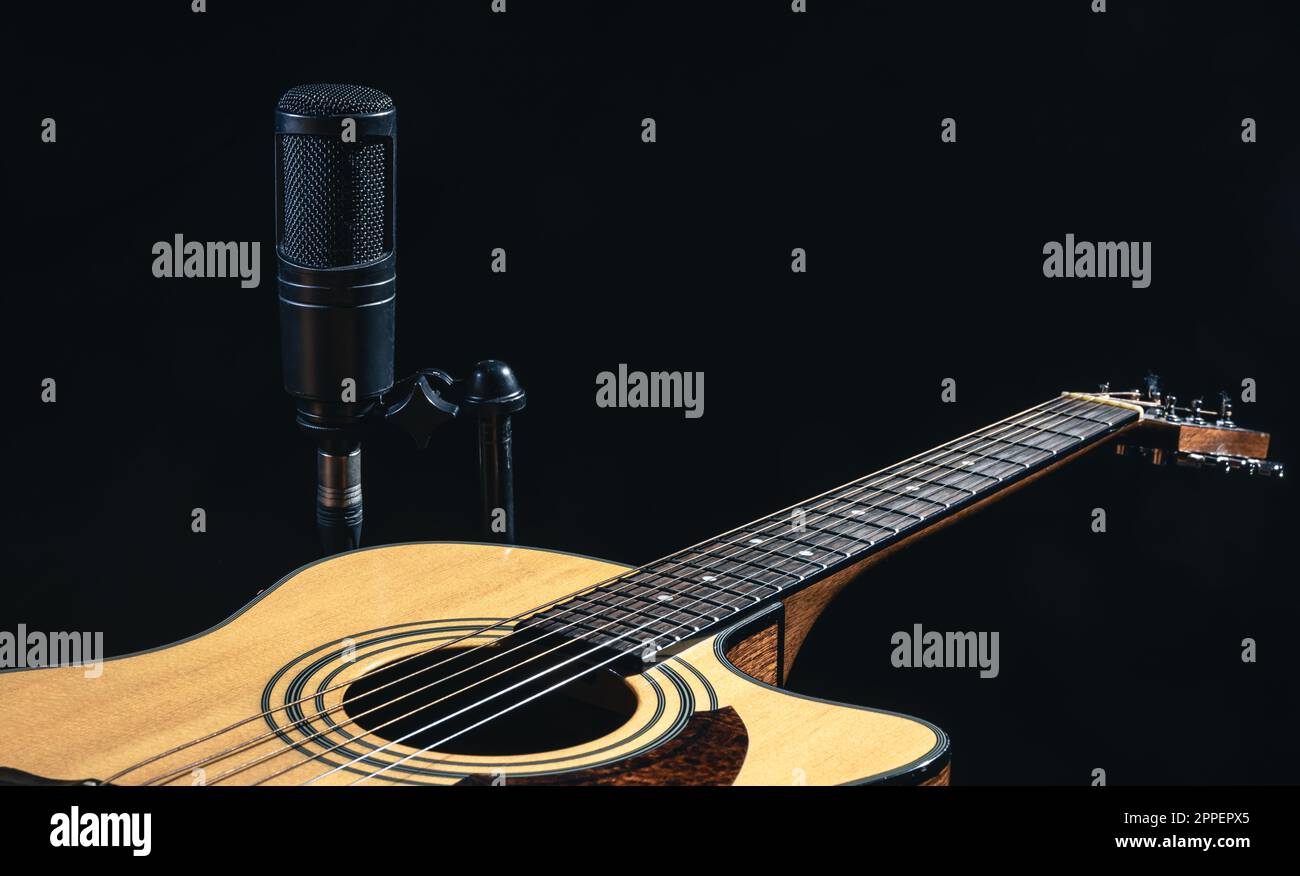 Close up of a classical light guitar and microphone, low key Stock ...