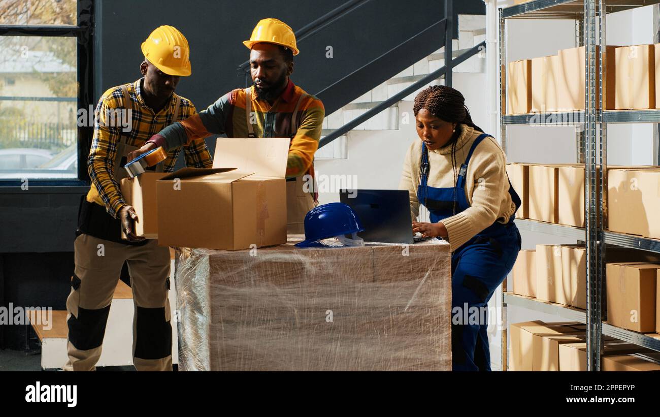 African american employees trained to use equipment, working in ...