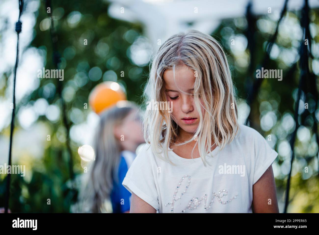 Front view of girl looking down Stock Photo - Alamy