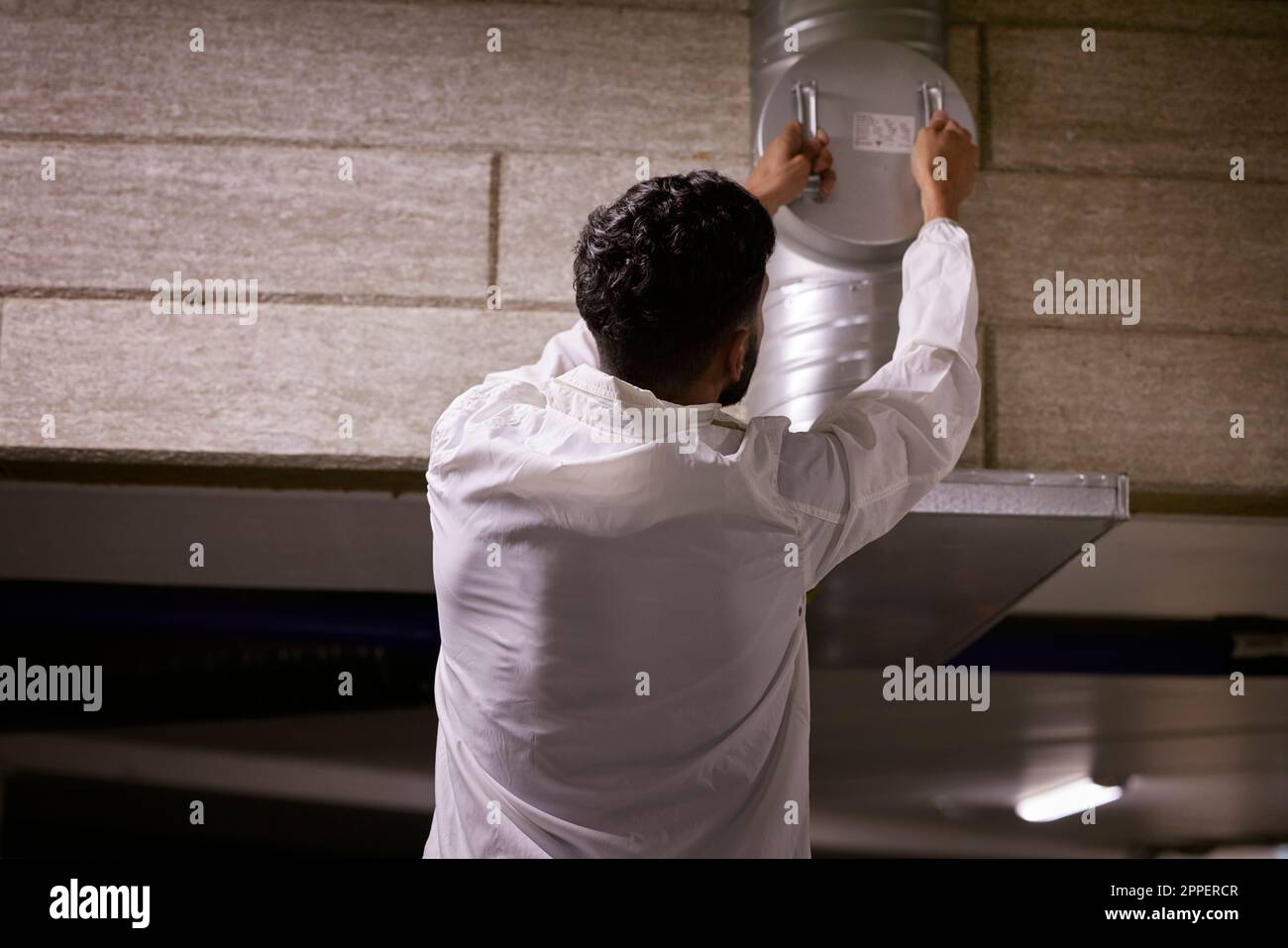 Man looking air conditioning hi-res stock photography and images - Alamy