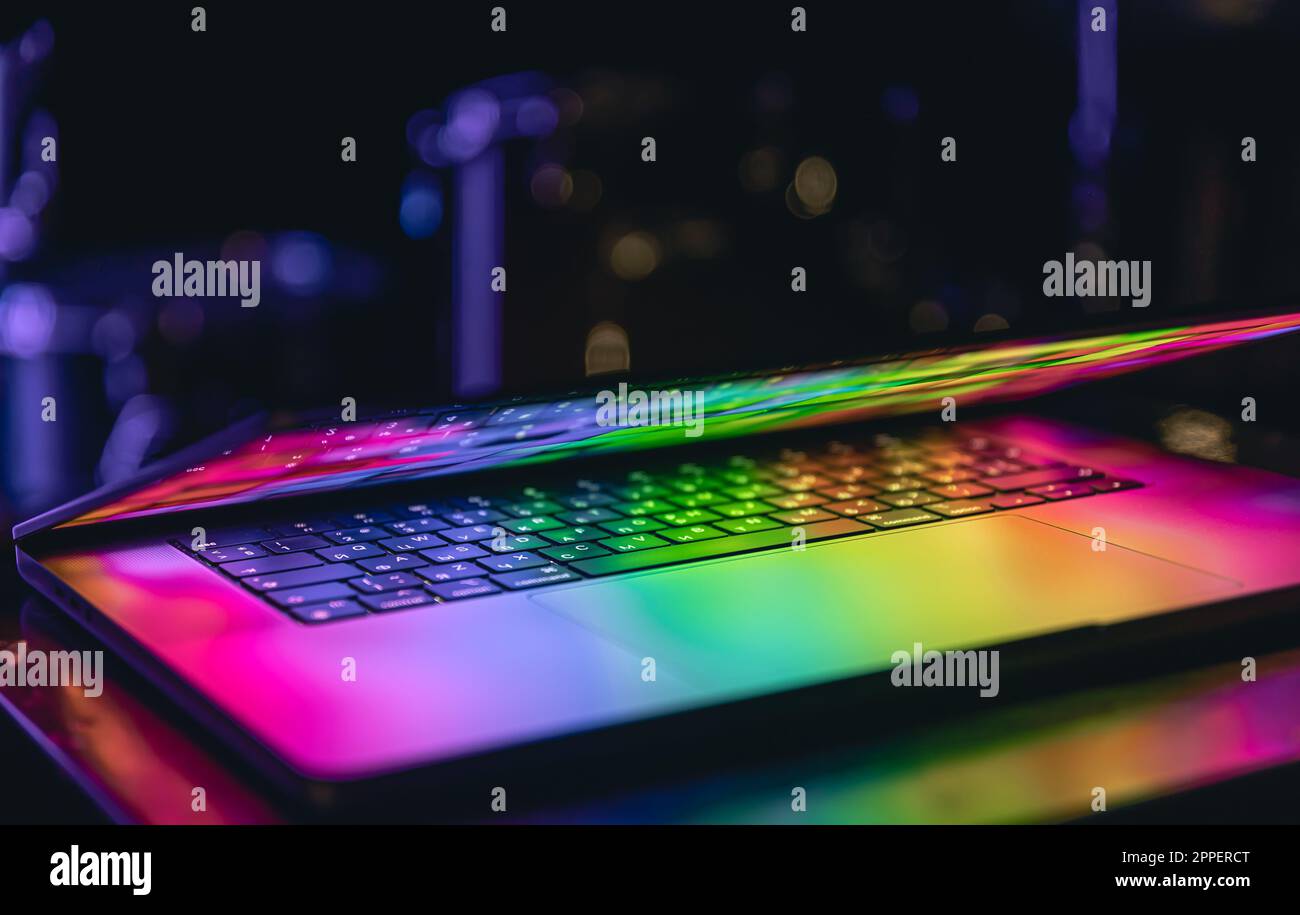 Close up of laptop keyboard colorful neon illumination, backlit ...