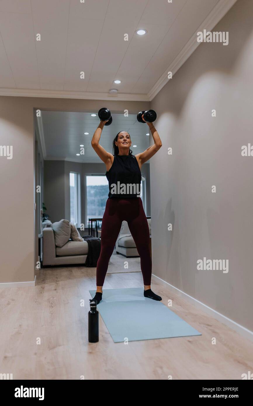 Exercising dumbbell home hi-res stock photography and images - Alamy