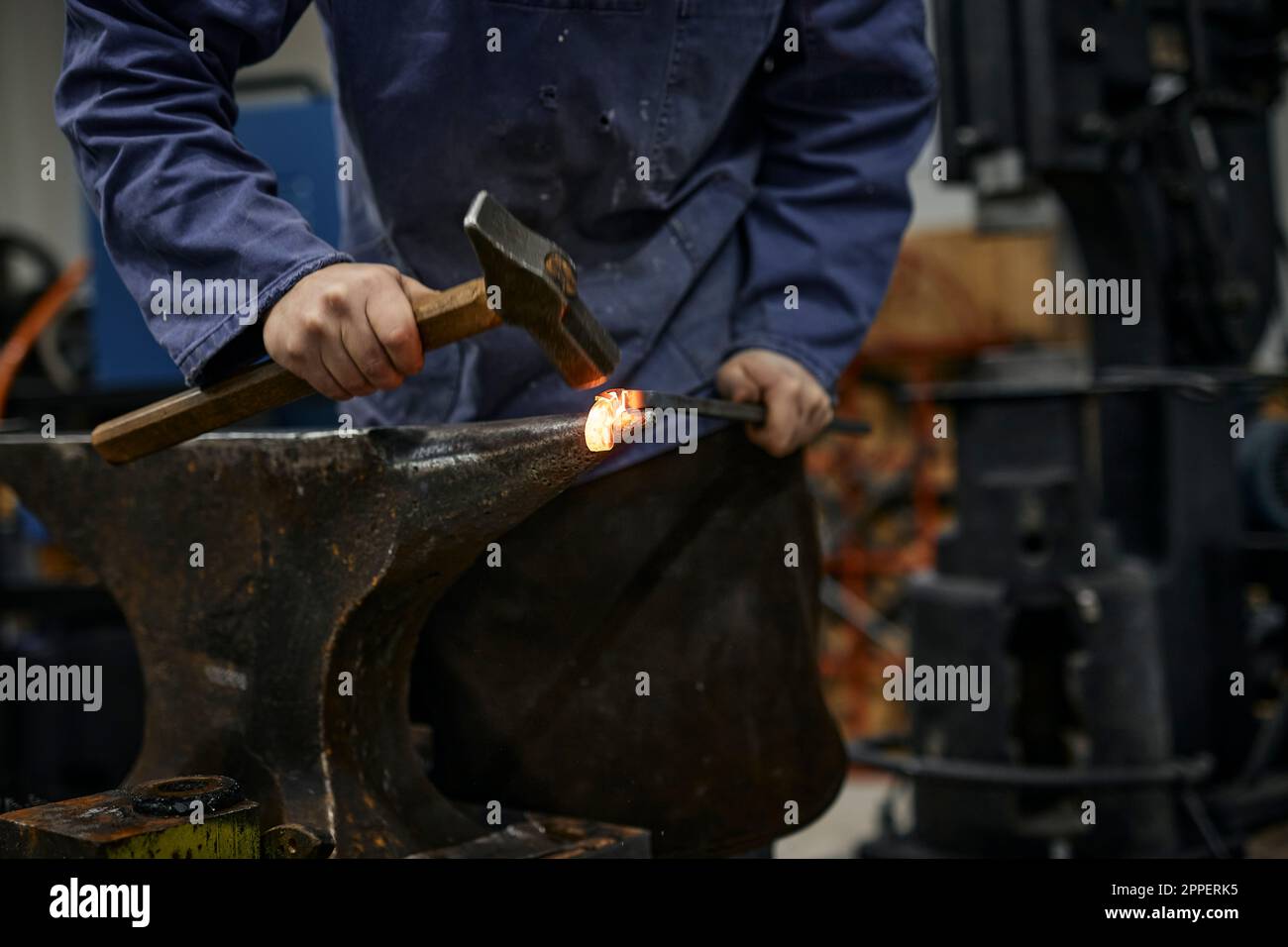 Blacksmith working in his workshop Stock Photo - Alamy
