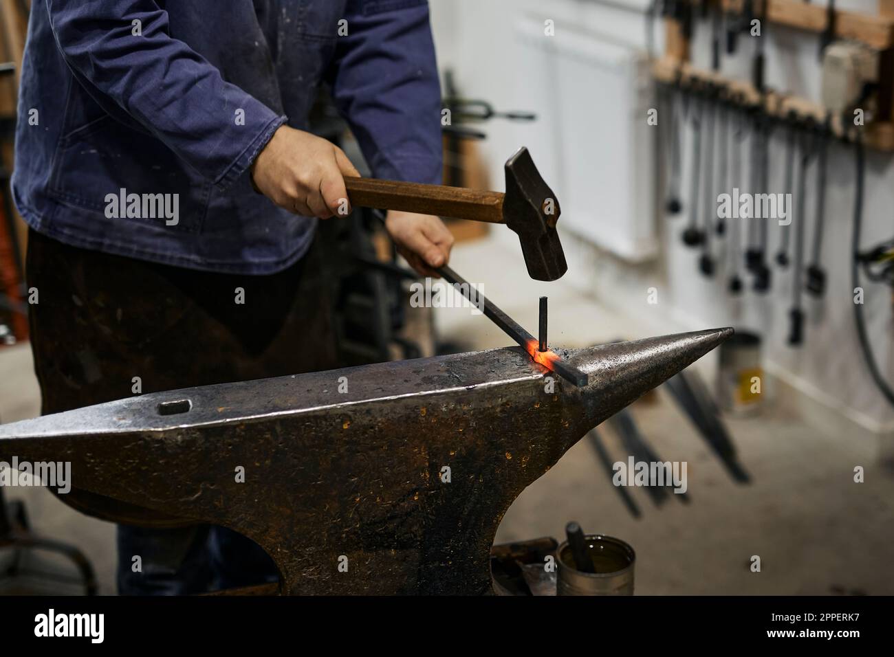 Blacksmith working in his workshop Stock Photo - Alamy