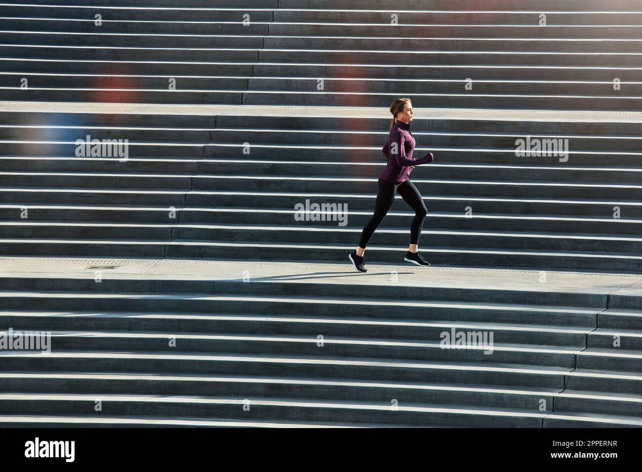 Model running down stairs hi-res stock photography and images - Alamy