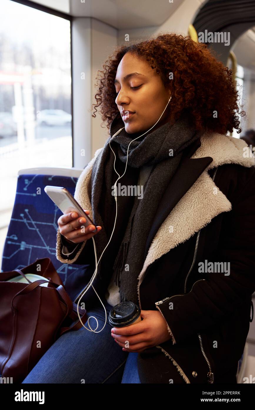 People using phones train hi-res stock photography and images - Alamy