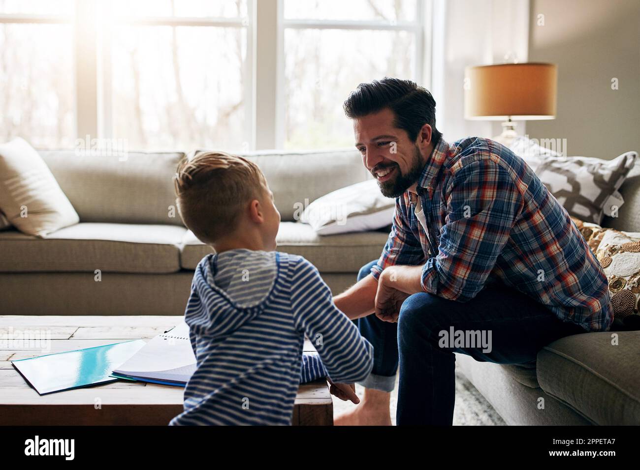 Yes we can play after youve finished your homework. a father helping ...