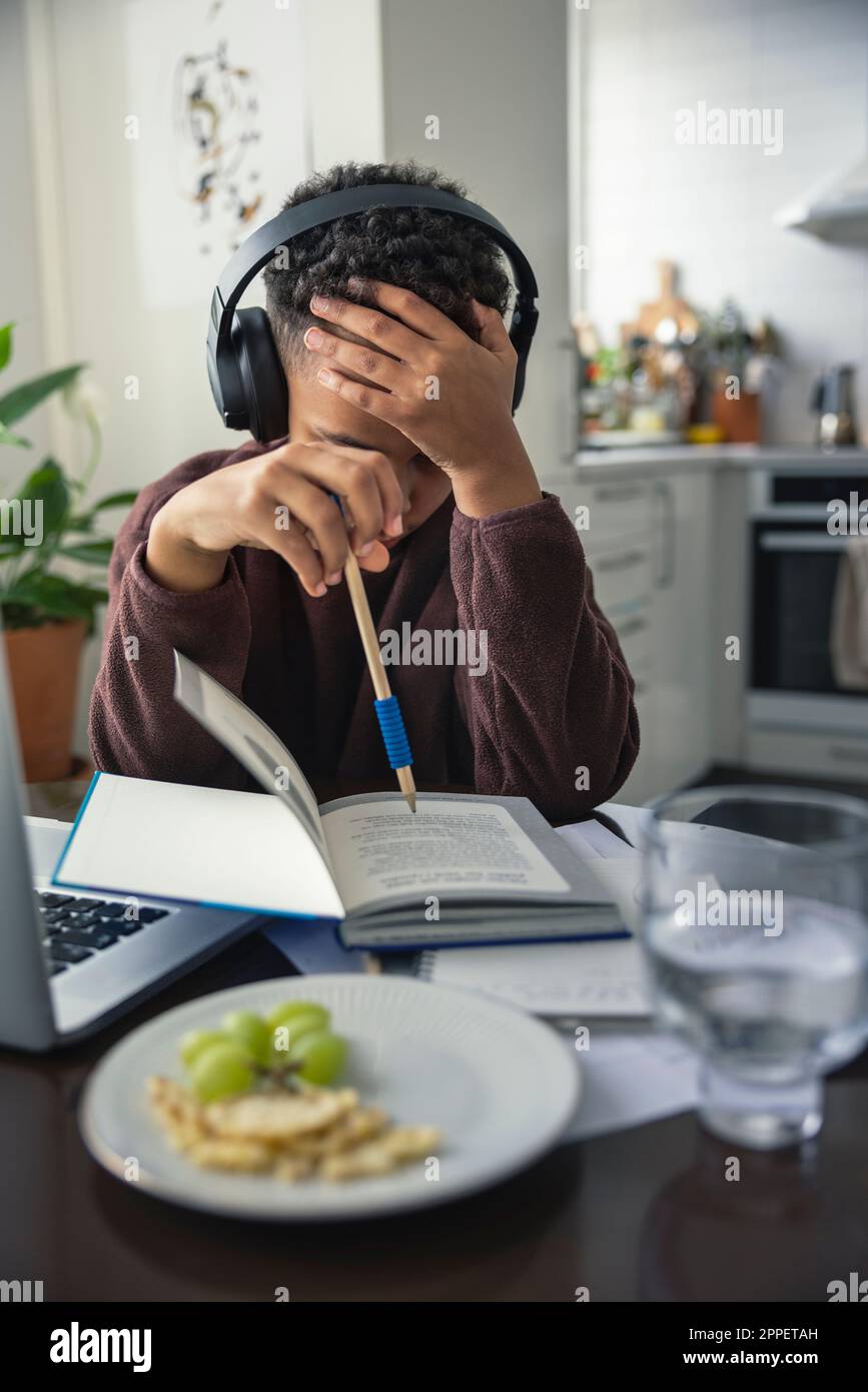 Boy doing homework at home Stock Photo - Alamy