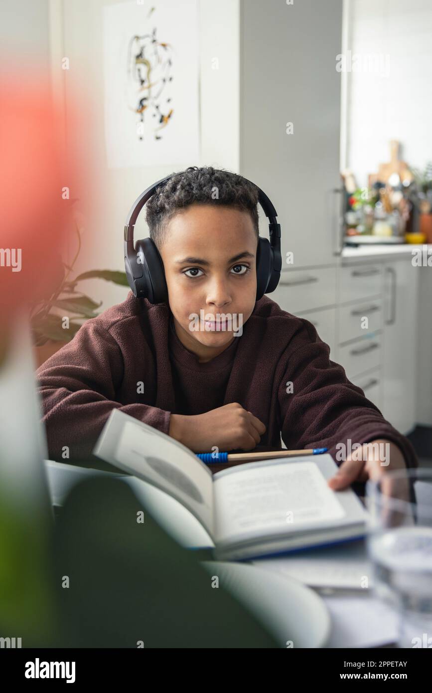 Boy doing homework at home Stock Photo - Alamy