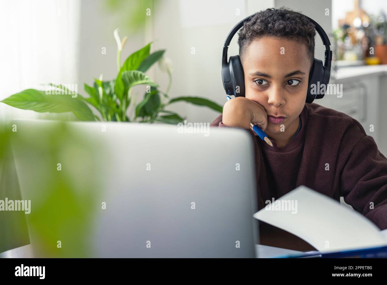 Boy doing homework at home Stock Photo - Alamy