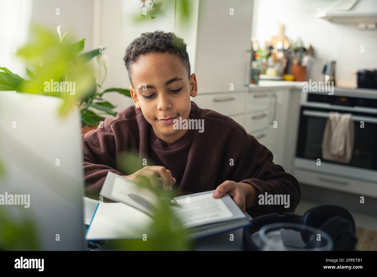Smiling boy doing homework hi-res stock photography and images - Alamy