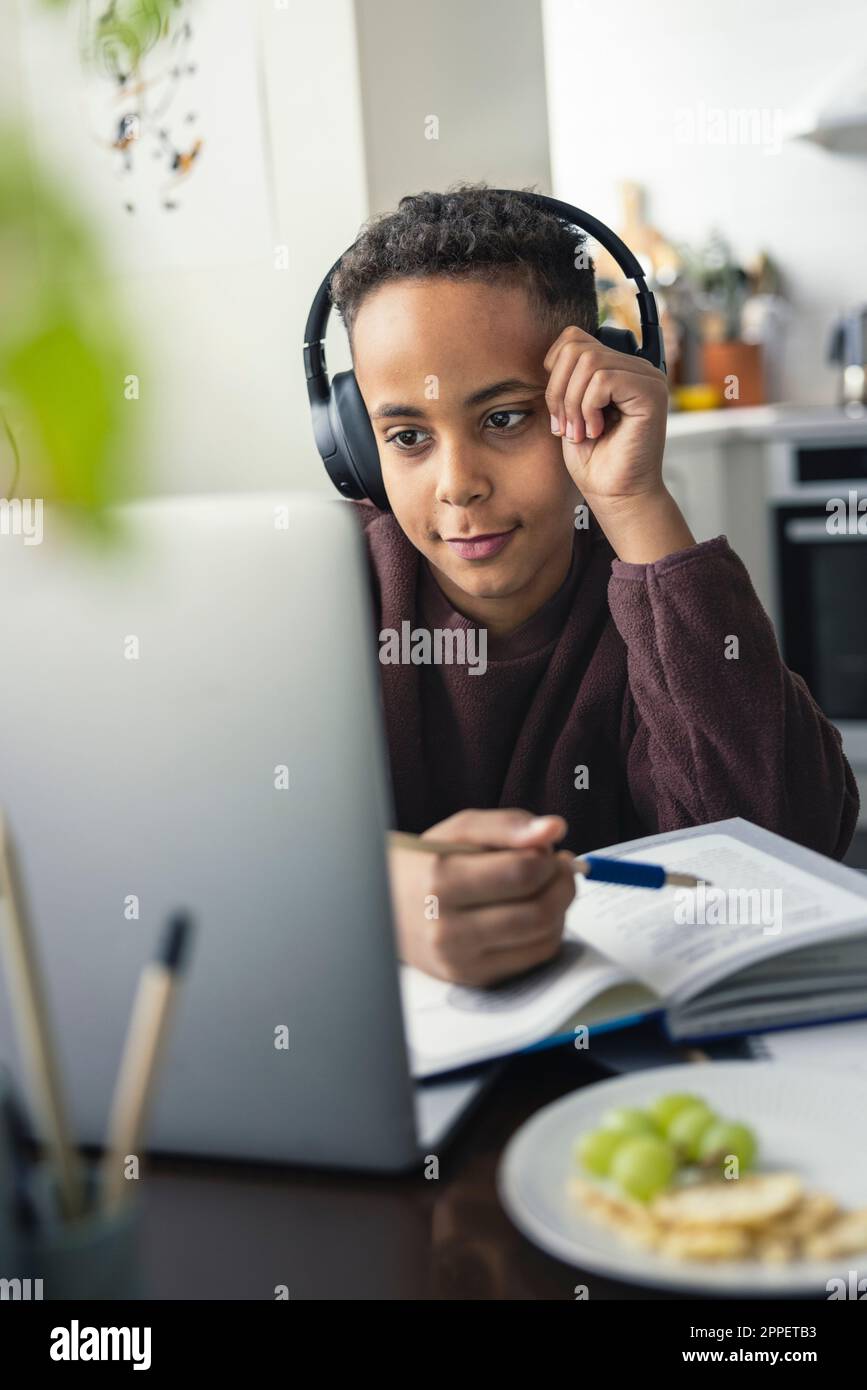Boy doing homework at home Stock Photo - Alamy