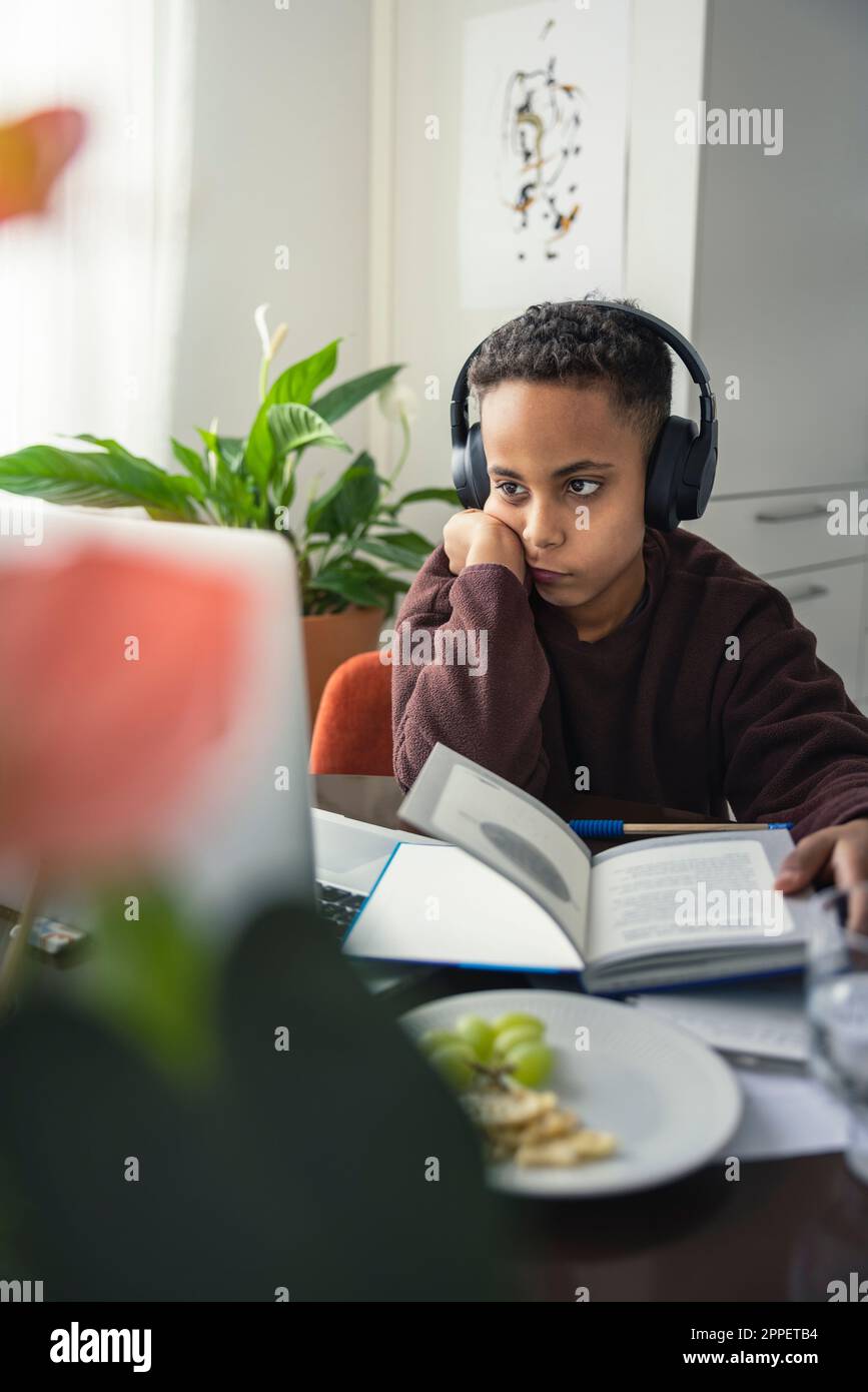 Boy doing homework at home Stock Photo - Alamy