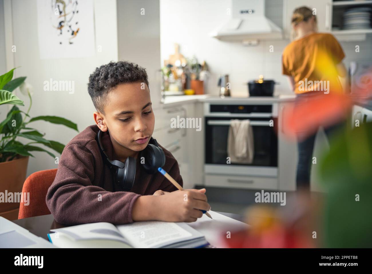 Boy doing school homework writing hi-res stock photography and images ...