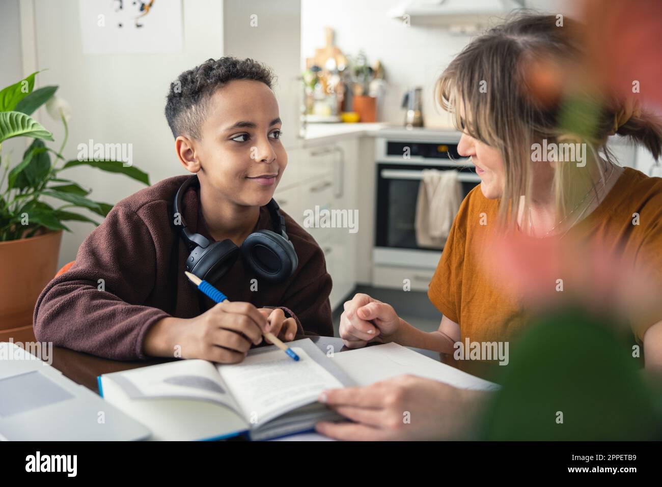 Mother helping son with homework Stock Photo - Alamy