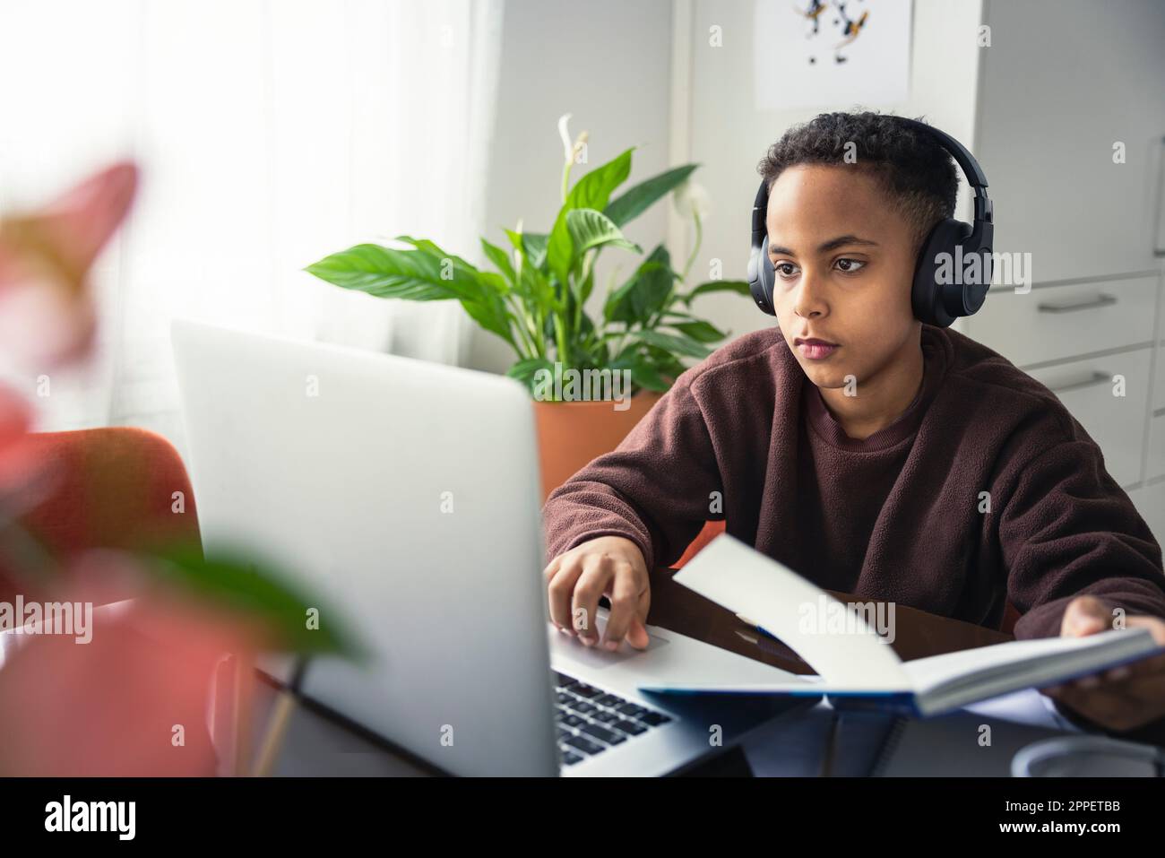 Boy doing homework laptop hi-res stock photography and images - Alamy