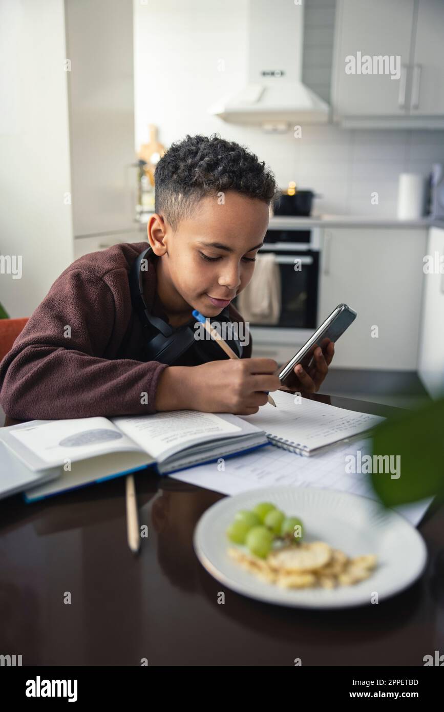Boy doing homework at home Stock Photo - Alamy
