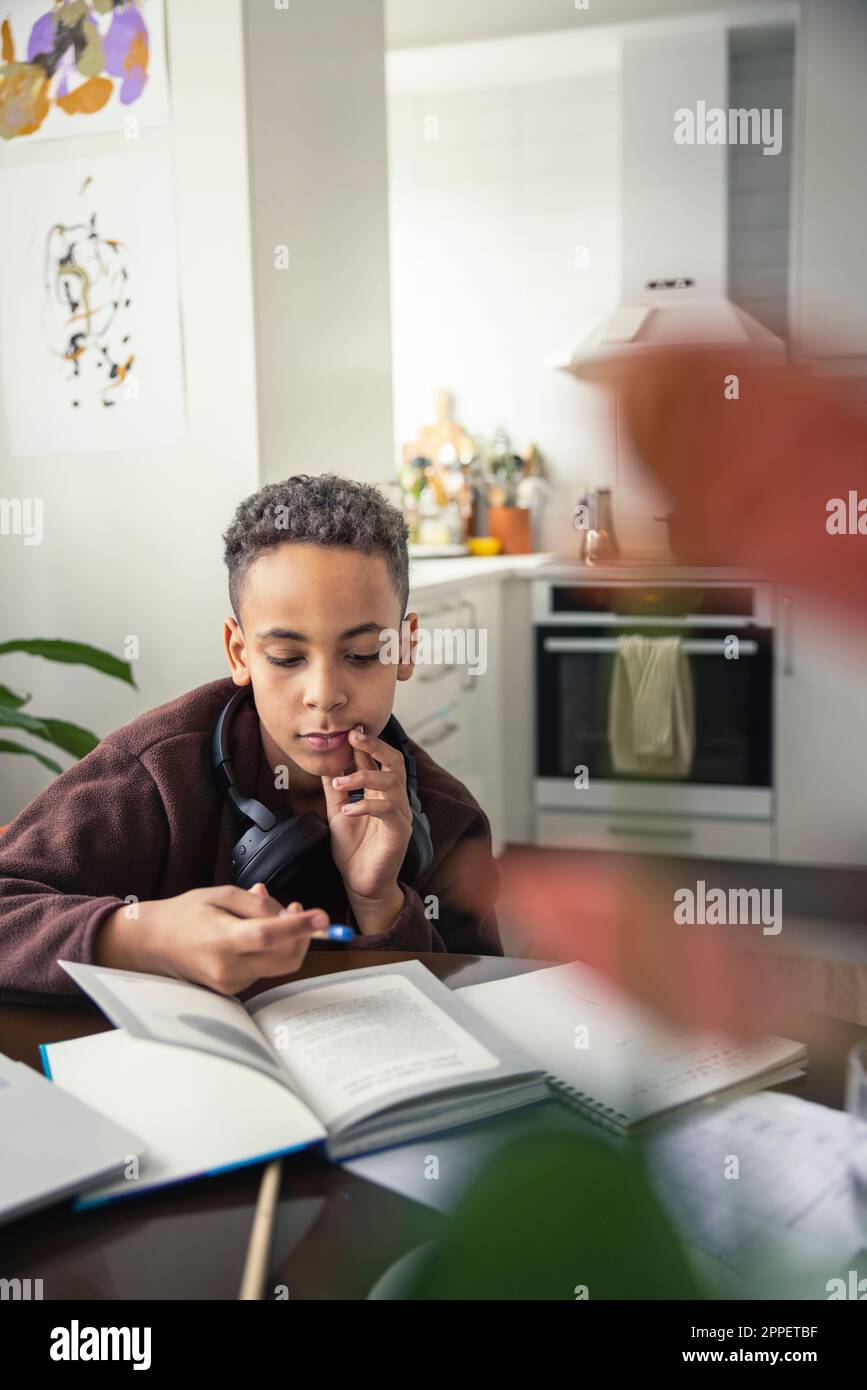 Boy doing school homework writing hi-res stock photography and images ...