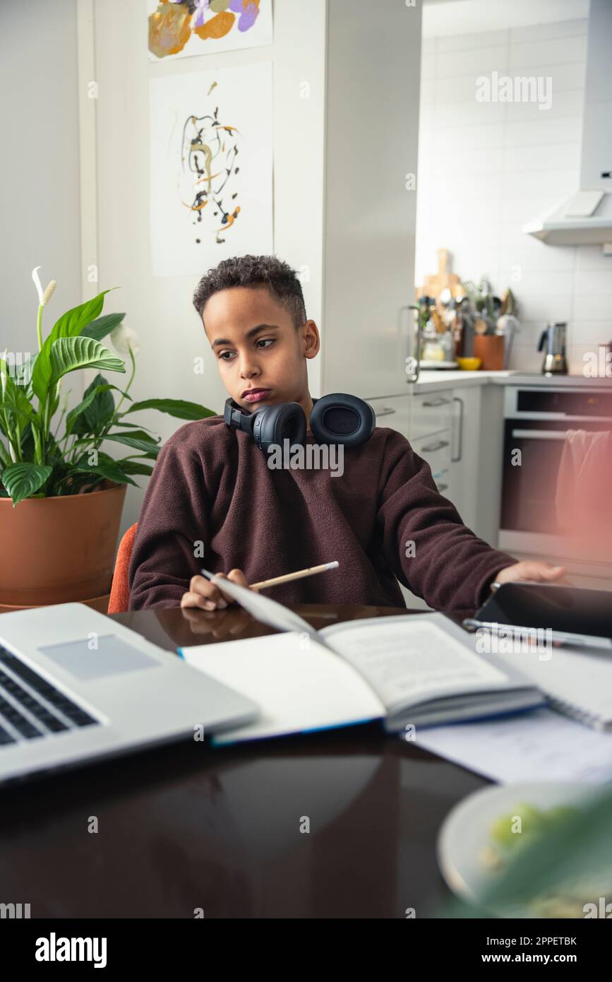 Boy doing homework at home Stock Photo - Alamy